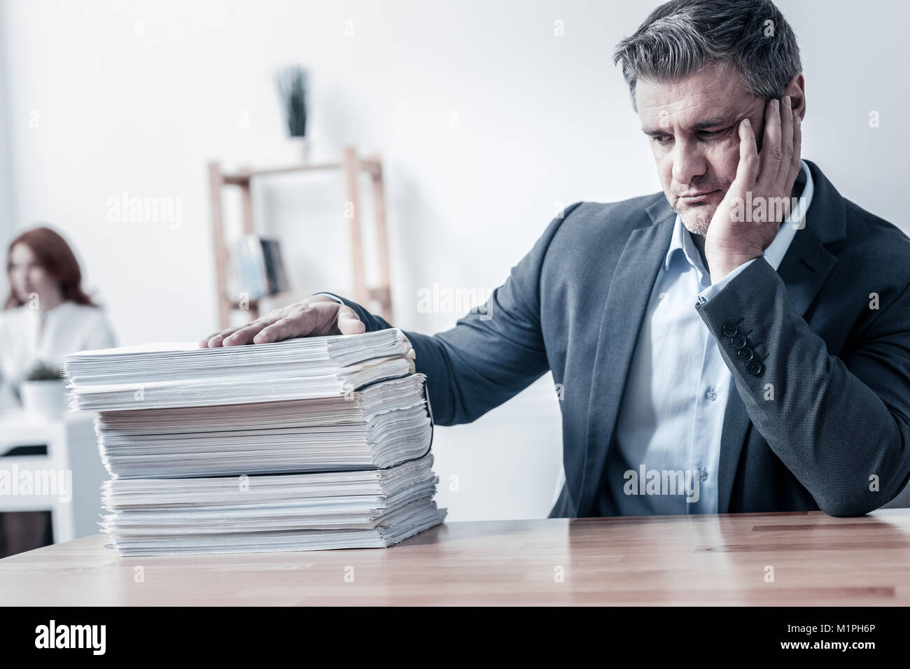 Stressed office worker pile paper hi-res stock photography and images ...