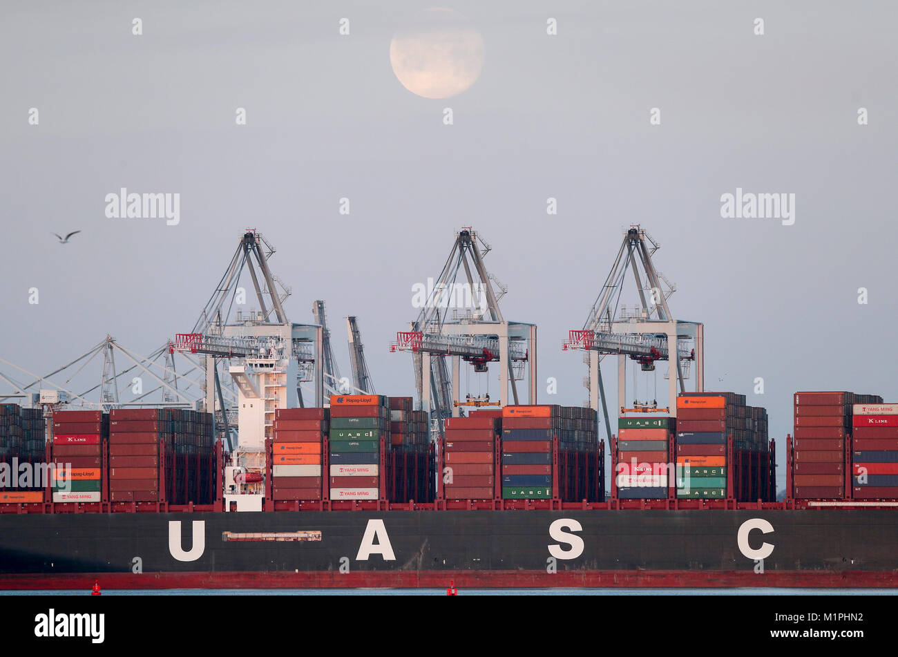 A generic stock photo of the moon over a container ship at Southampton ...