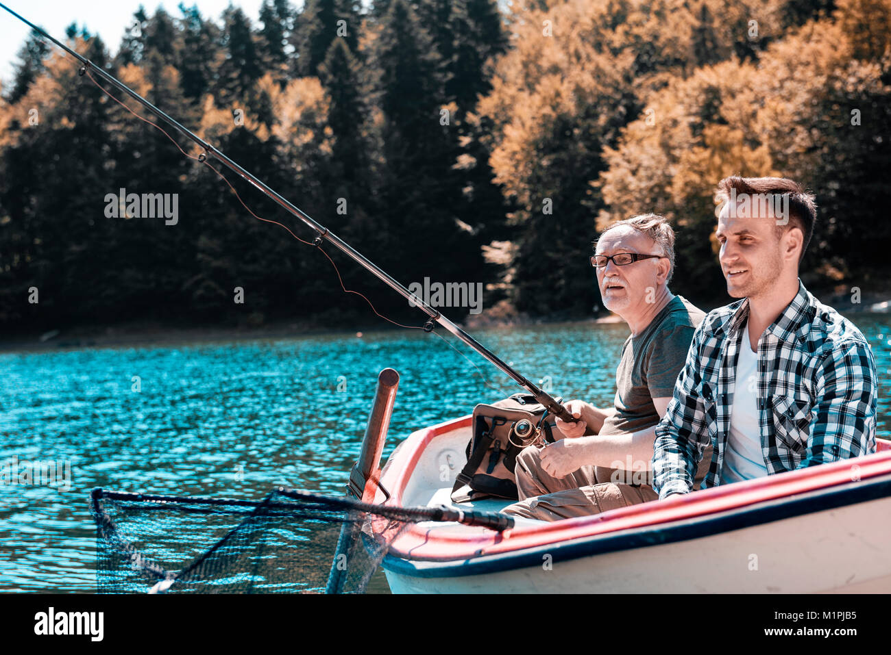 Man catching fish in canoe hi-res stock photography and images - Alamy