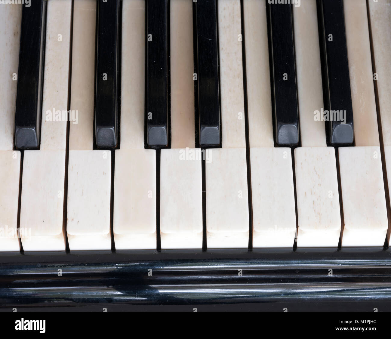 closeup of black and white keys on old ivory keyboard of antique ...