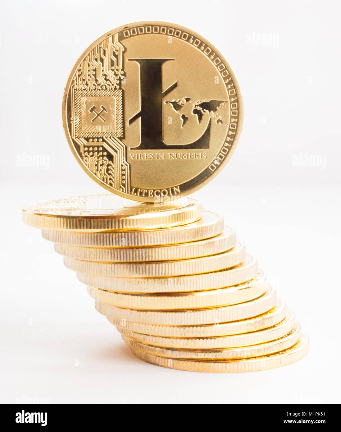 On a gray background are gold coins of a digital crypto currency ...