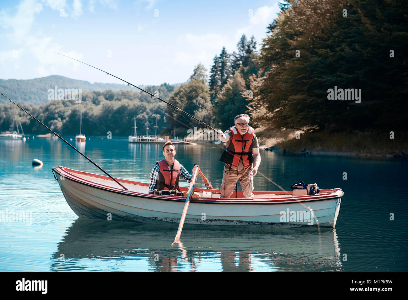 Two men catching fish hi-res stock photography and images - Alamy