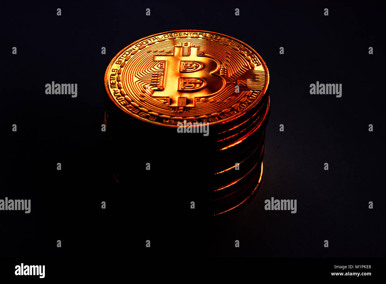 On a black background are gold coins of a digital crypto currency ...