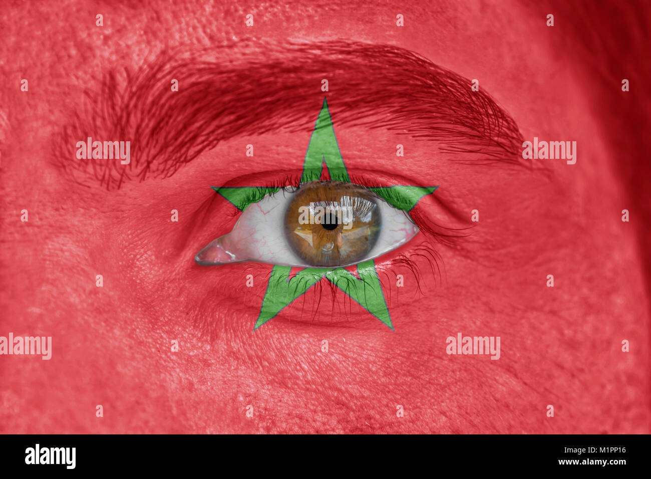 Human face and eye painted with flag of Morocco Stock Photo - Alamy