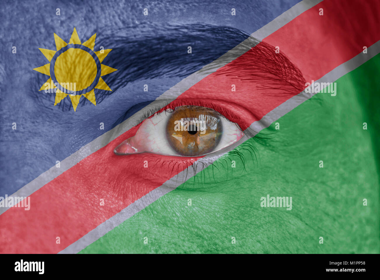 Human face and eye painted with flag of Namibia Stock Photo - Alamy