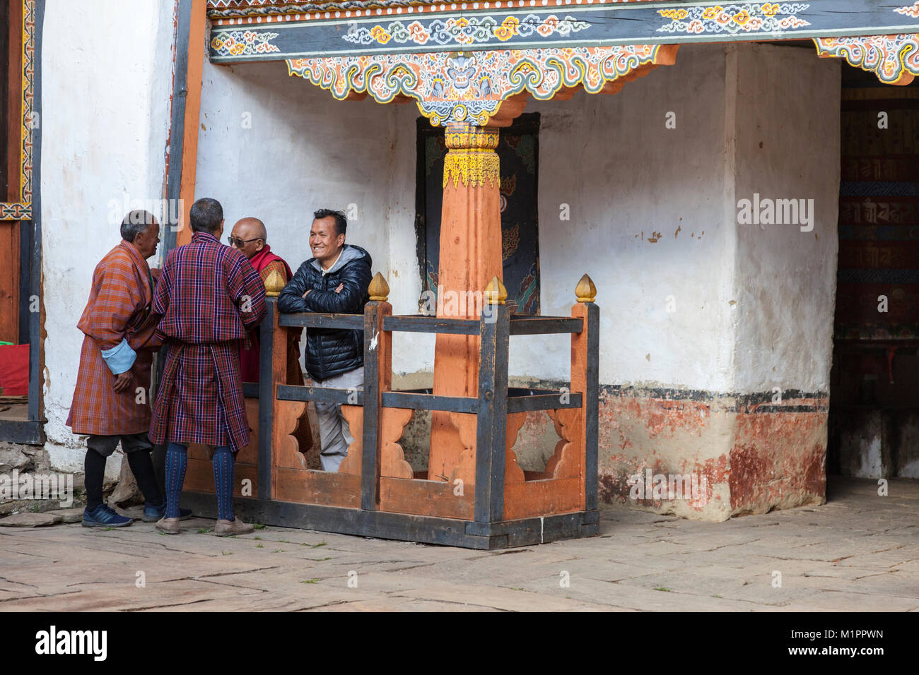 Bumthang, Bhutan. Men Talking. Three Wearing Traditional Gho. Jambay ...