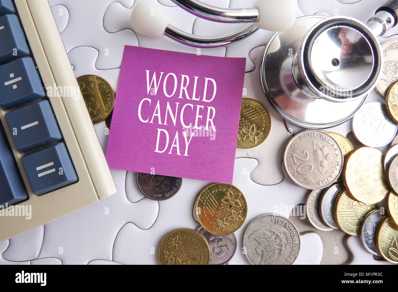 WORLD CANCER DAY CONCEPT; Stethoscope,jigsaw puzzle and sticker Stock ...