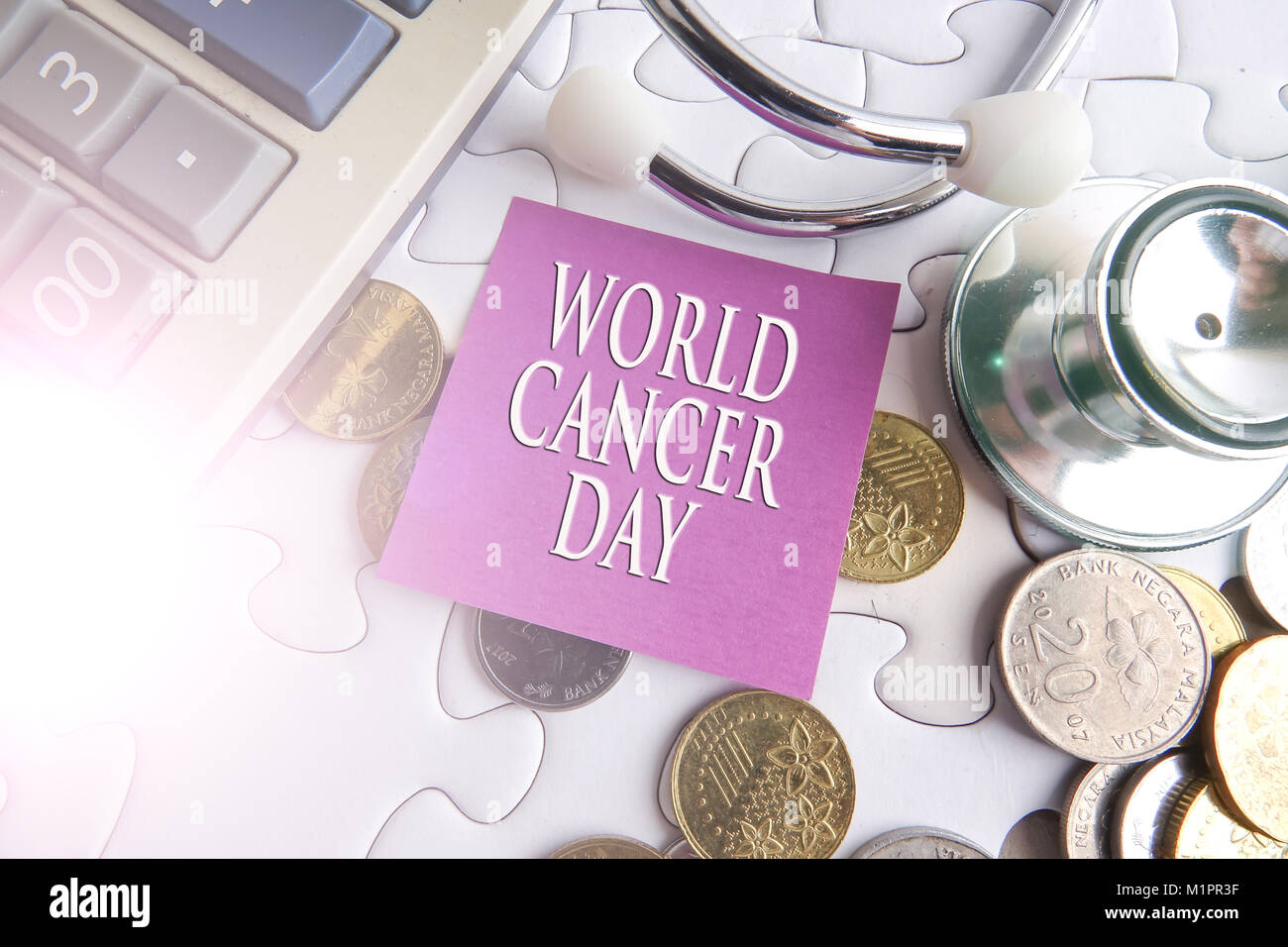 WORLD CANCER DAY CONCEPT; Stethoscope,jigsaw puzzle and sticker Stock ...