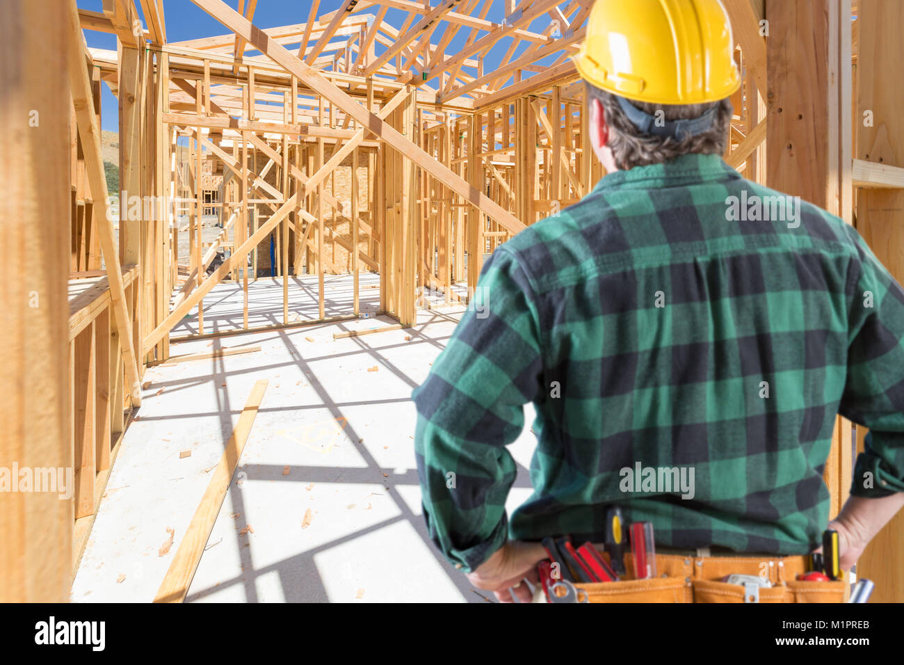 Contractor Standing Inside Construction Framing of New House Stock ...