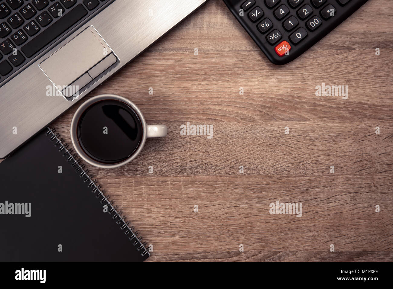 Laptop computer or notebook, calculator and cup of coffee on working ...