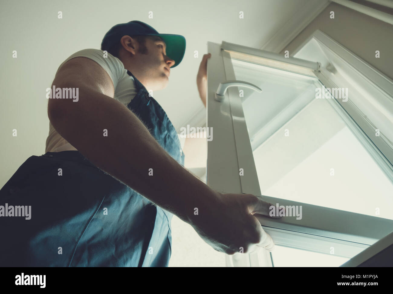 Professional handyman installing window at home Stock Photo - Alamy