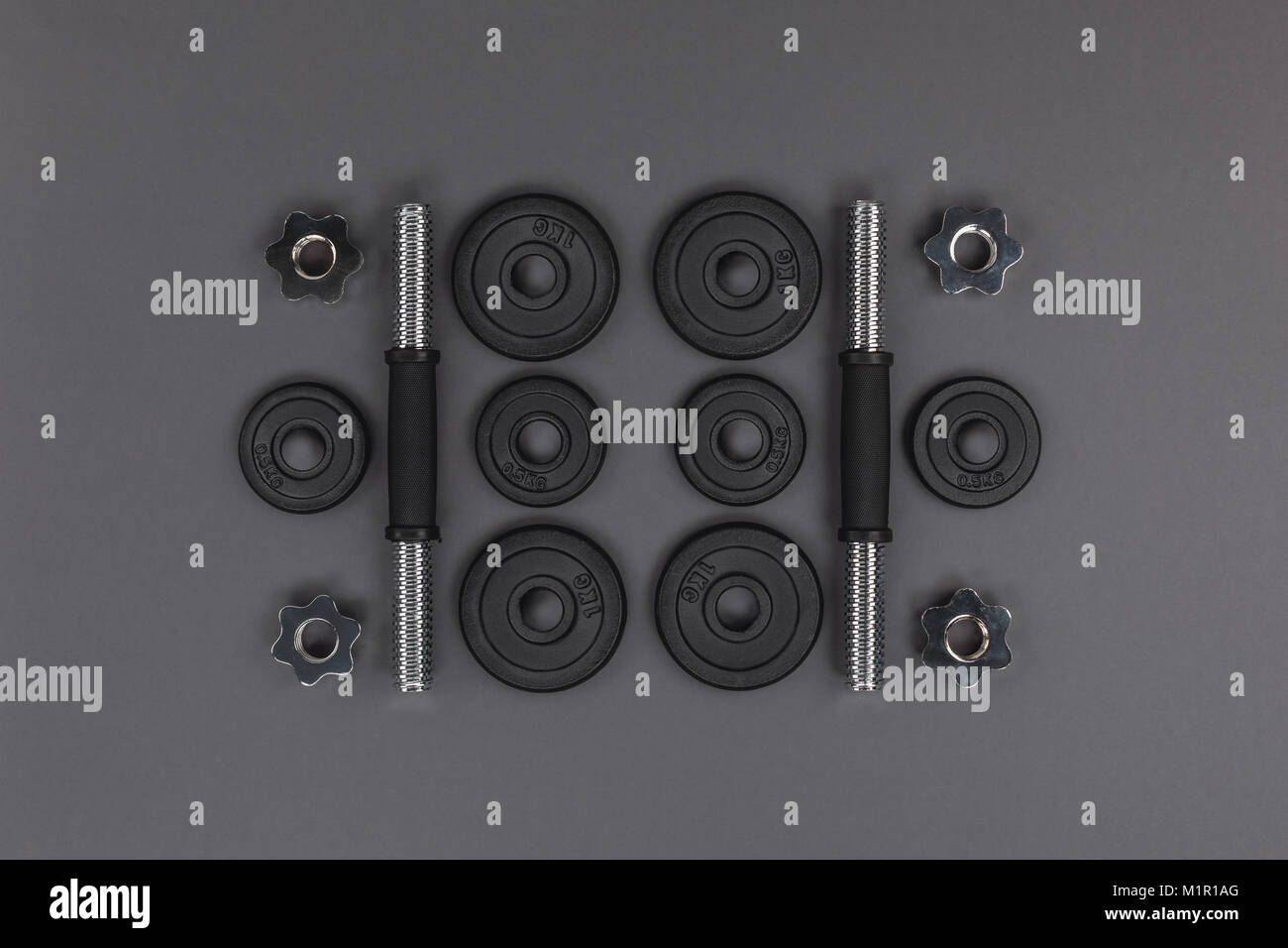 flat lay with various metal barbells and weight plates isolated on grey ...