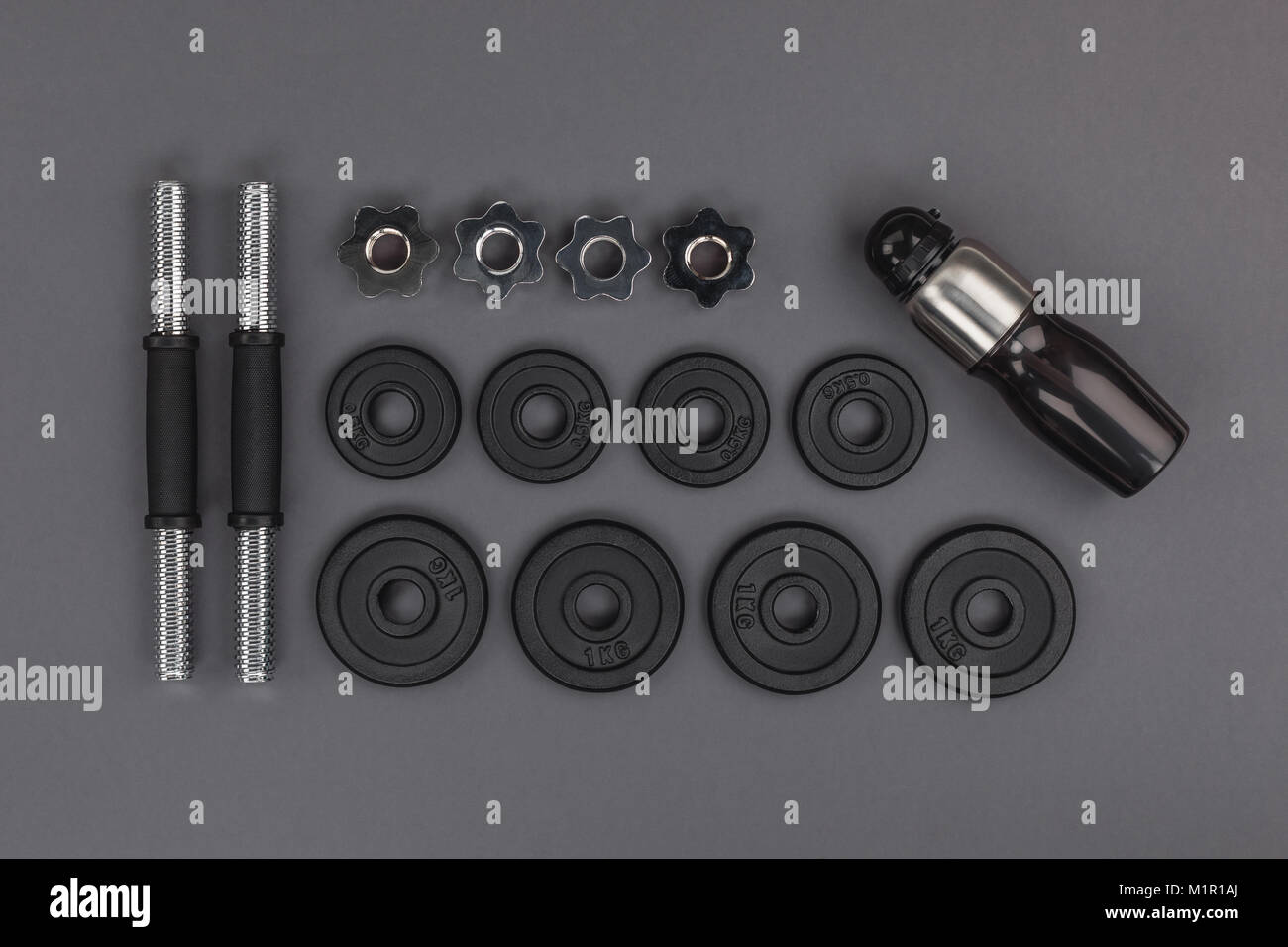 top view of various metal barbells and weights with shaker isolated on ...