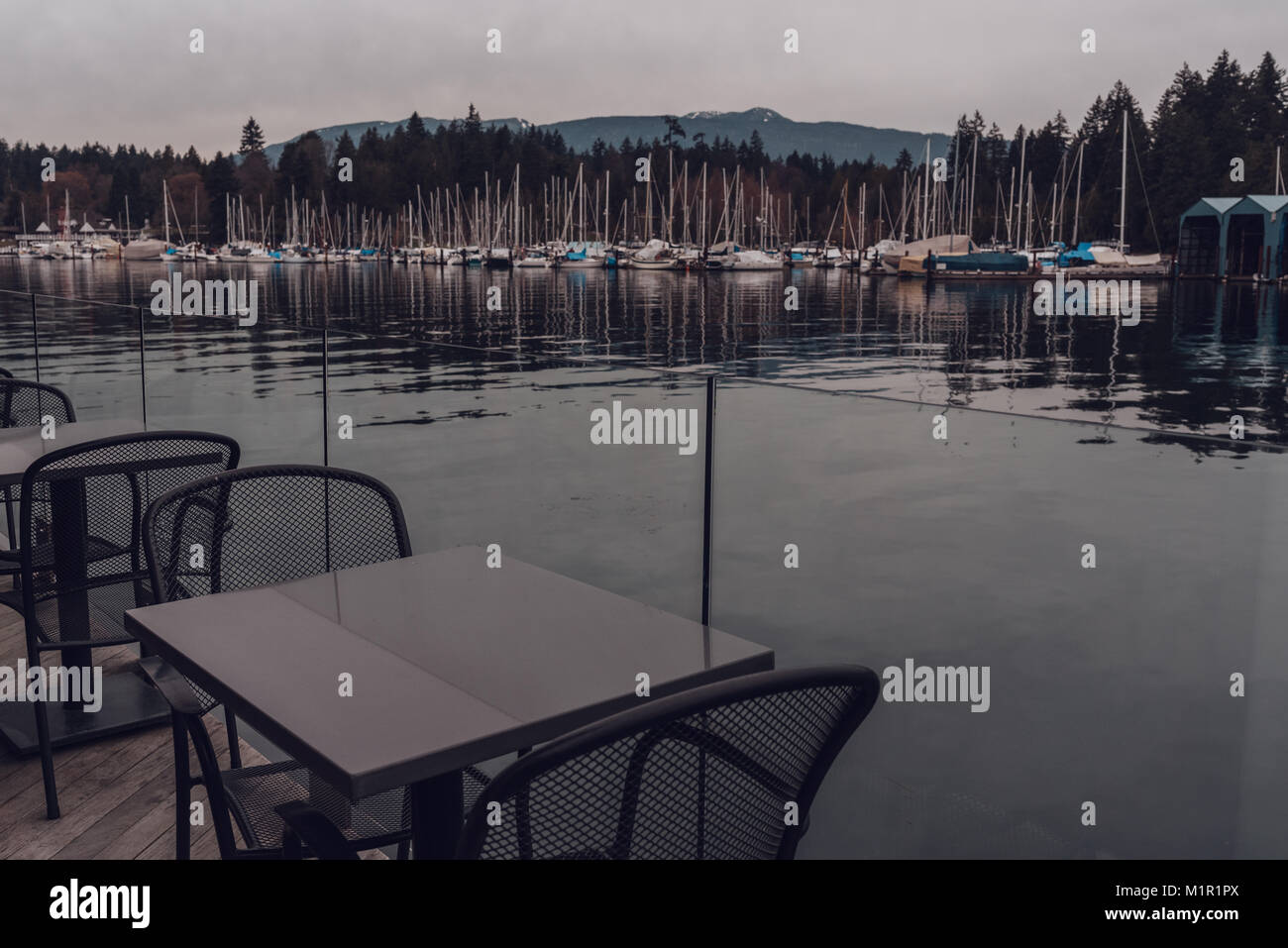 Table in a restaurant with a view to waterfront in downtown with boats ...