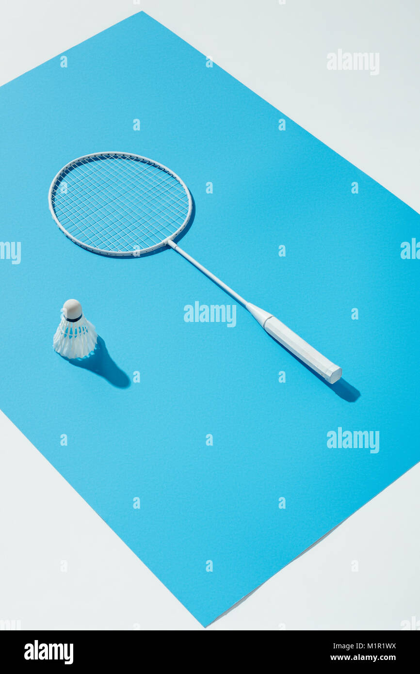 badminton racket and shuttlecock lying on blue paper Stock Photo - Alamy