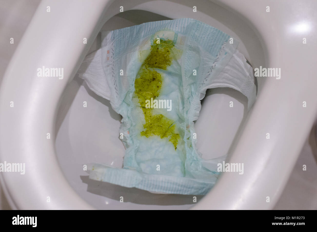 Close-up of yellow dirty stinky diaper of newborn baby lying in the ...