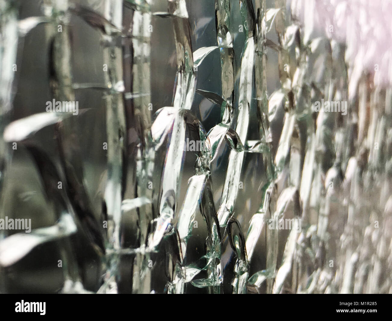 Close-up of broken glass wall shot at an angle with the blur at the ...