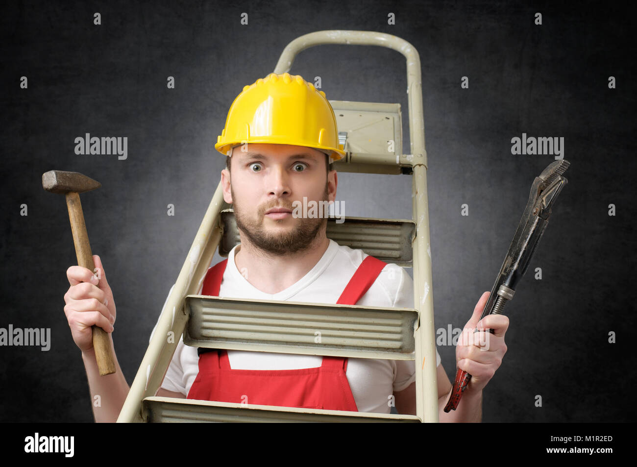 Clumsy worker with tools Stock Photo - Alamy