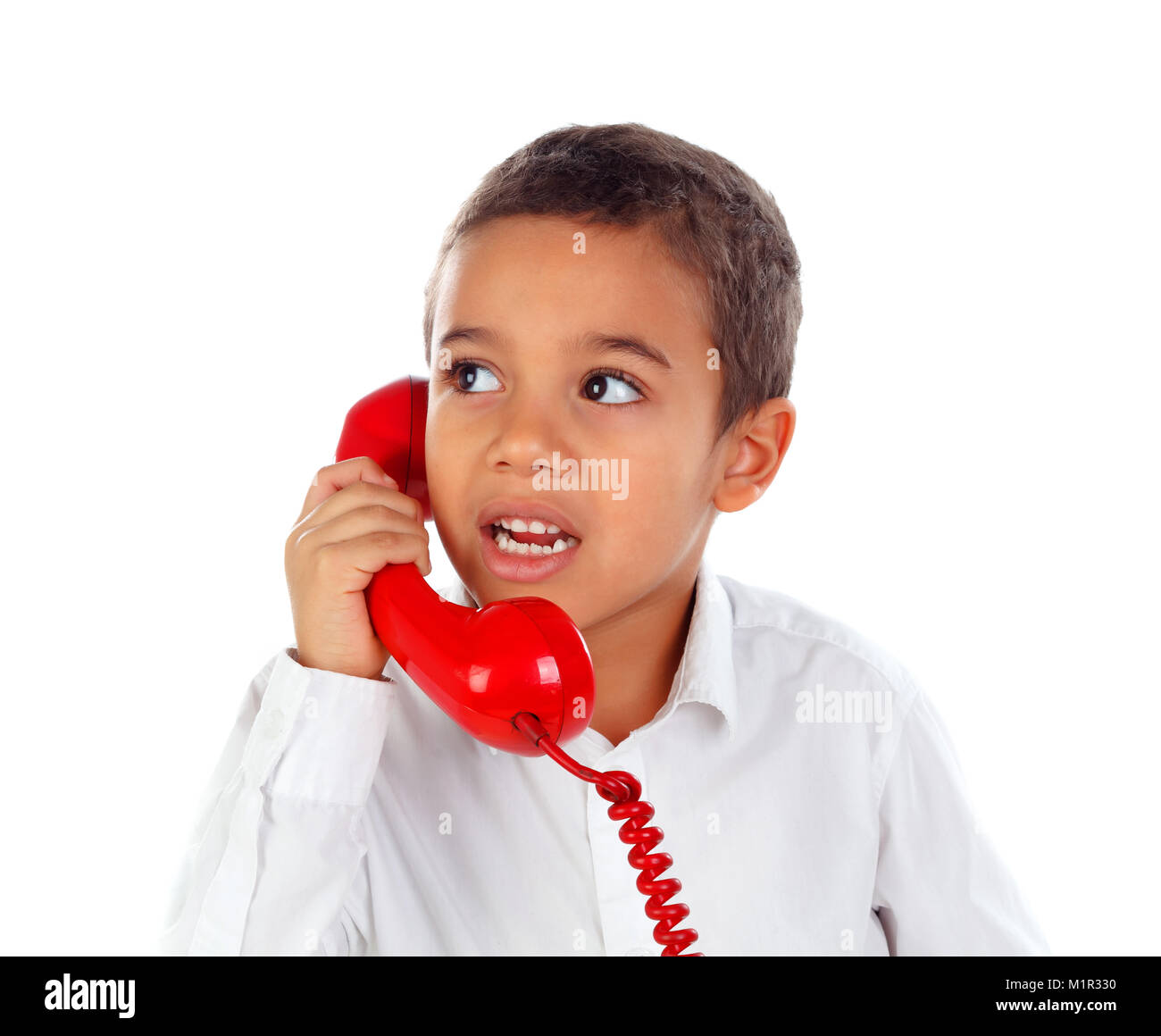 Funny small child talking on the phone isolated on a white background ...