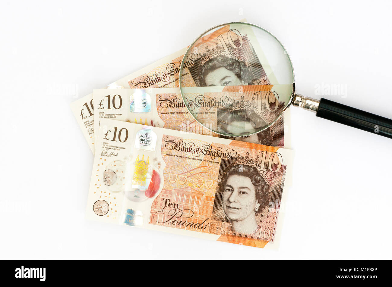 UK United Kingdom Polymer Ten 10 Pound Bank Notes under a magnifying ...