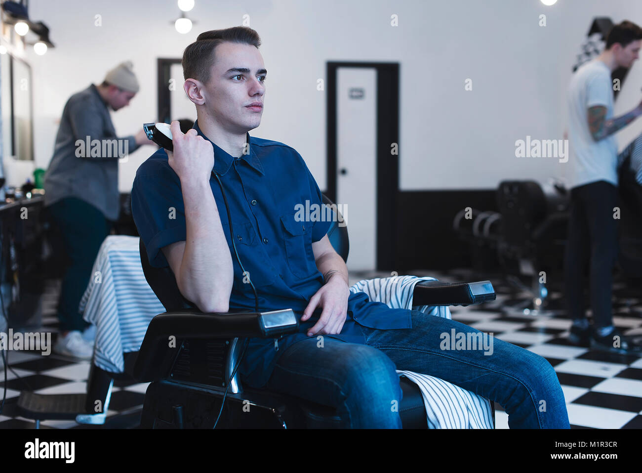 Barber on the chair. Barber expects the client to sit in the chair ...