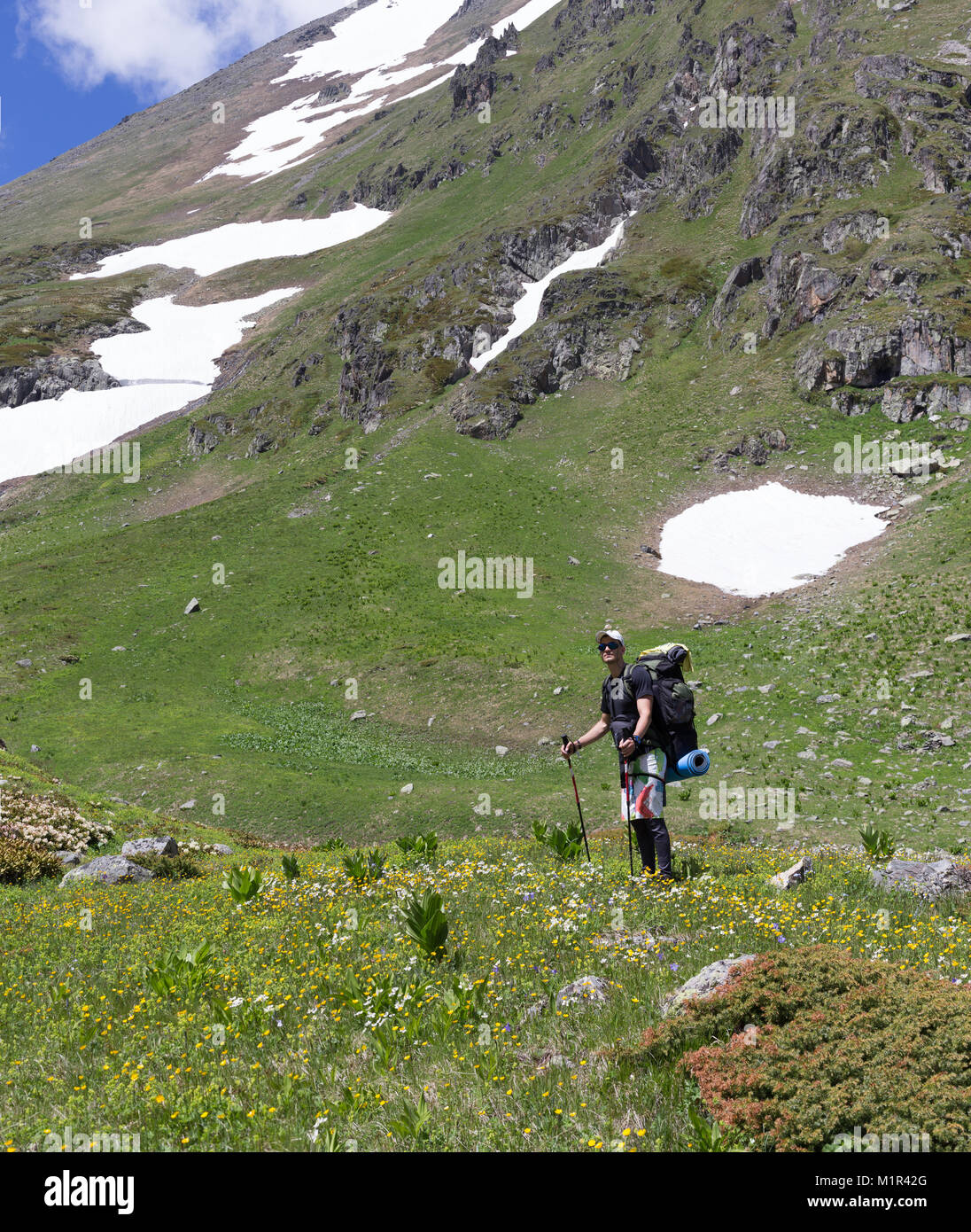 A traveler with a backpack in the background of idyllic landscapes with ...