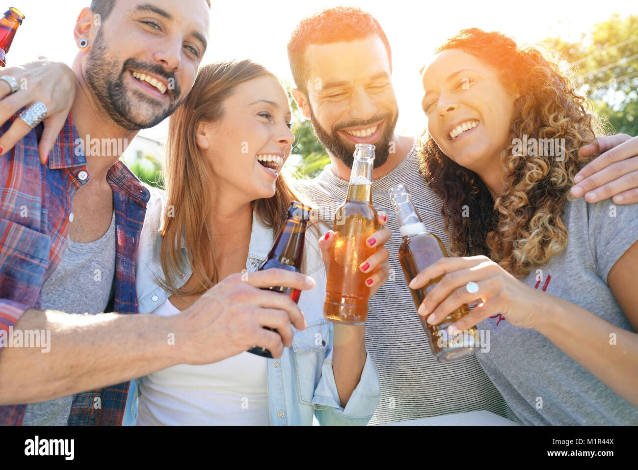 Group of friends gathering in bar drinking beers Stock Photo - Alamy