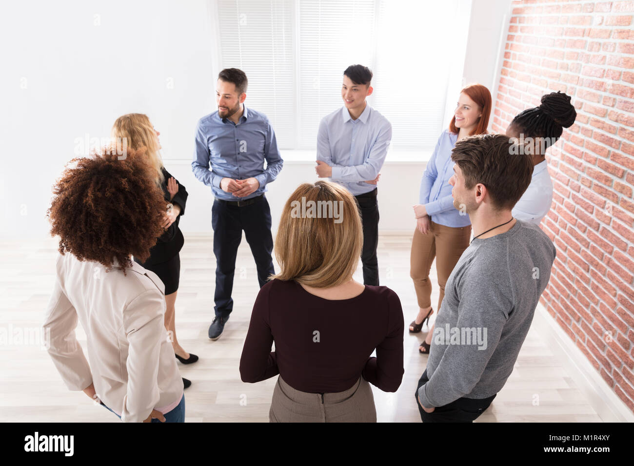 Diverse team colleagues having meeting hi-res stock photography and ...