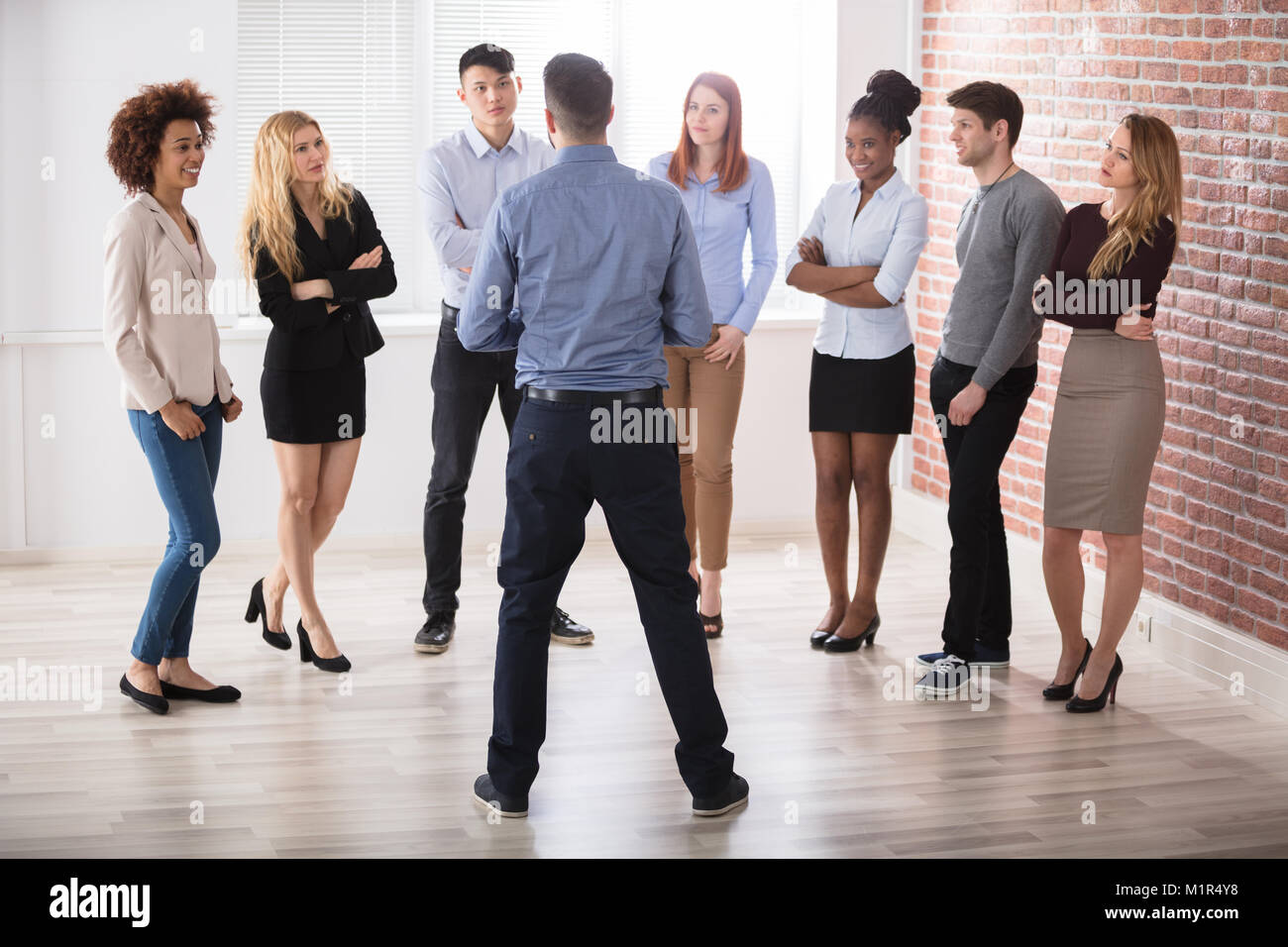 Rear View Of Manager Having Conversation With His Business Colleagues ...