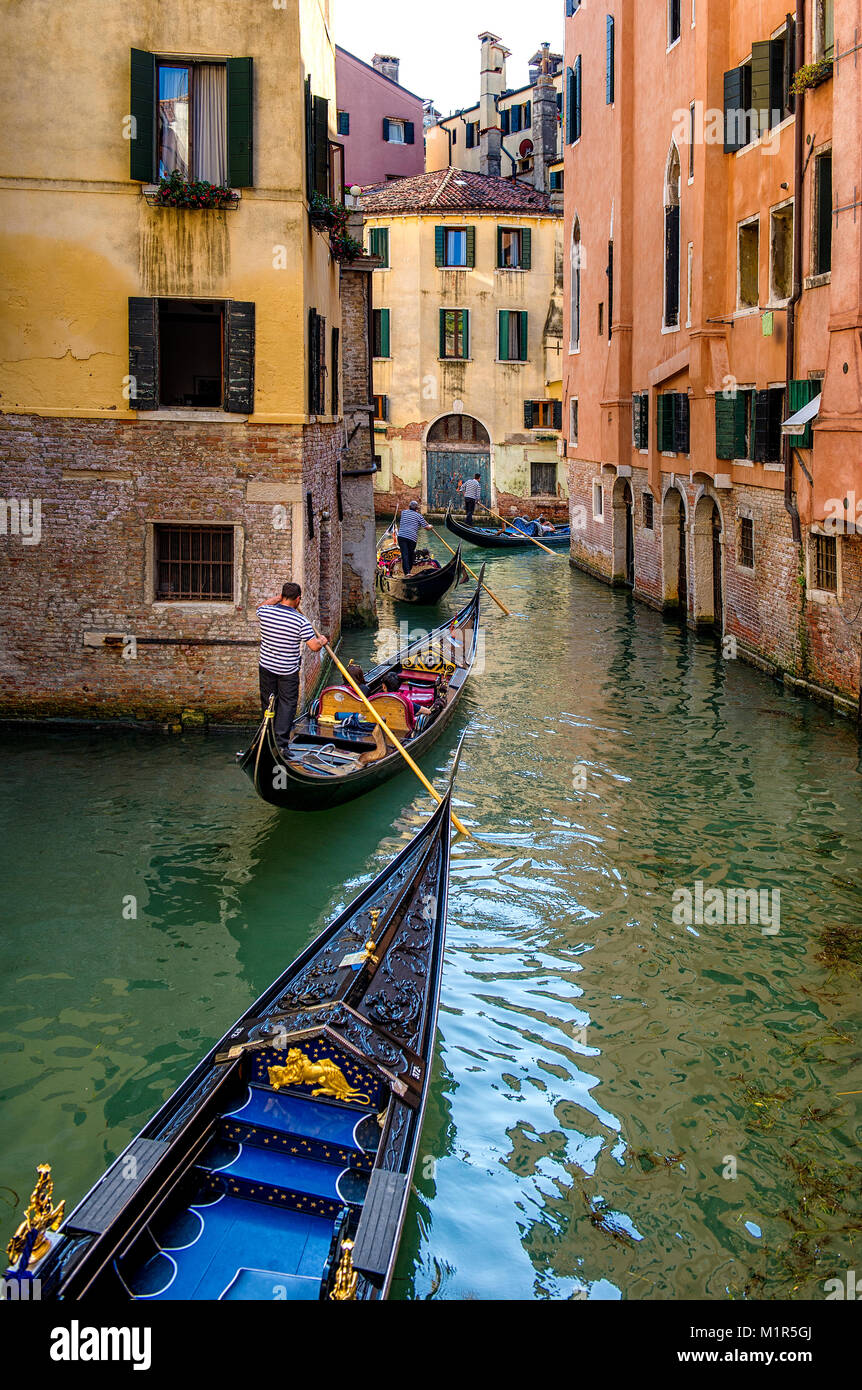 Tourists and workers pass by on the waterways of Venice's canal's. The ...
