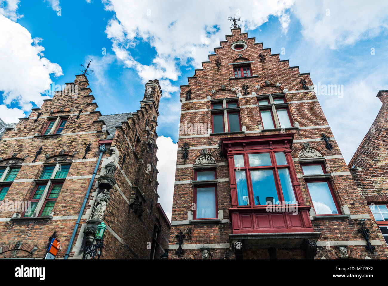 Facade of old historic buildings in the medieval city of Bruges ...