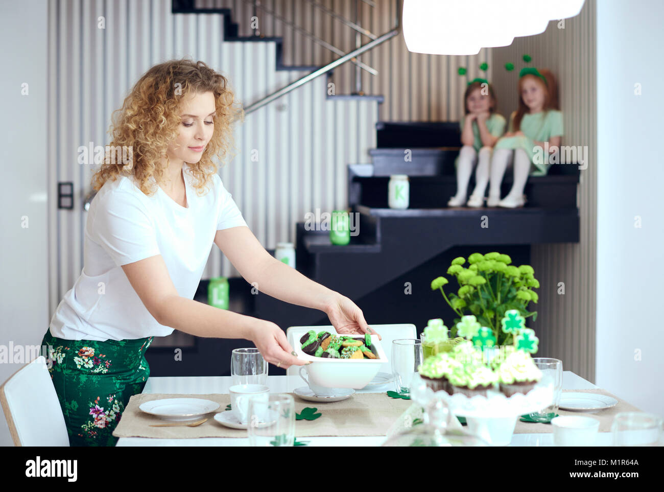 Attractive woman setting the table Stock Photo - Alamy