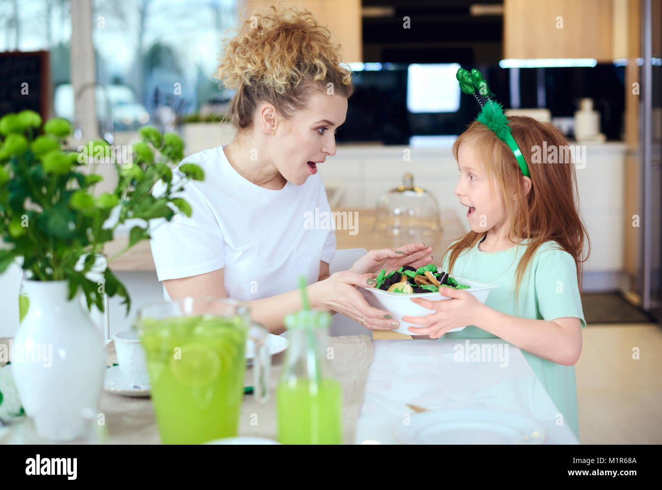 Child sharing cookies with mother Stock Photo - Alamy