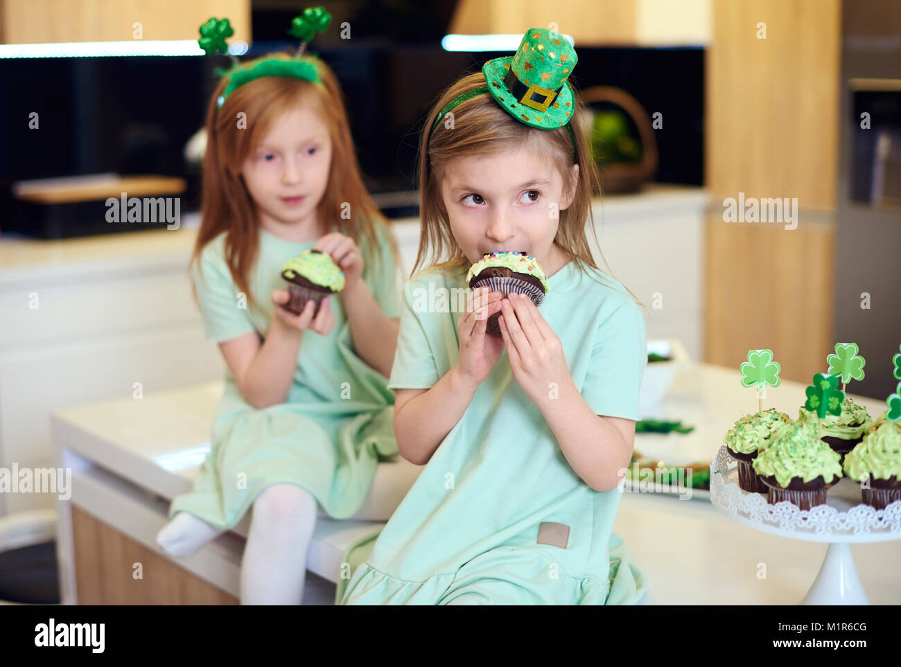 Portrait of children eating cupcake Stock Photo - Alamy