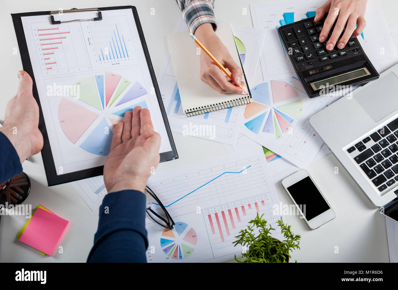 Business people discussing the charts and graphs showing the results of ...