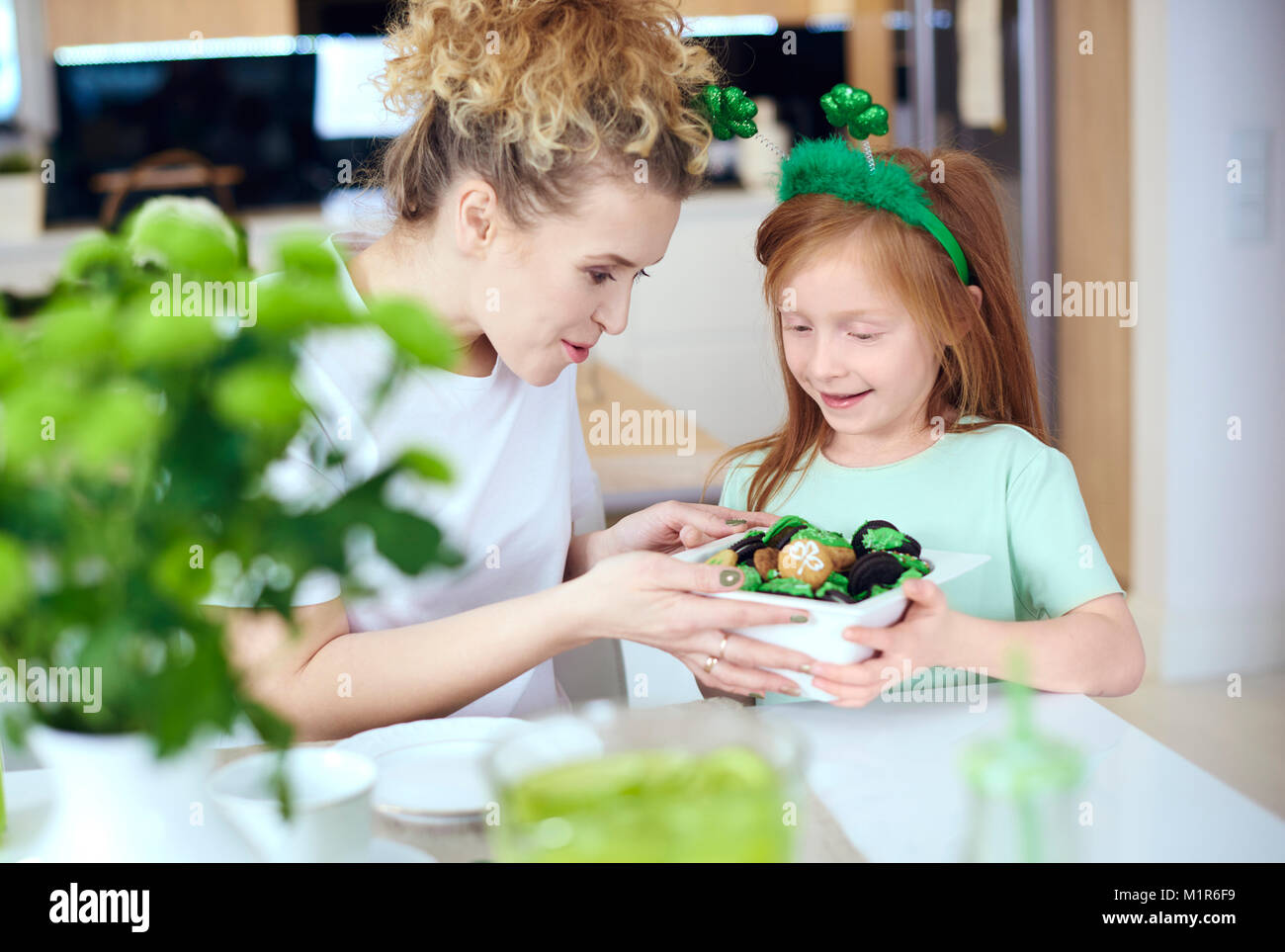 Cheerful girl helping her mother Stock Photo - Alamy