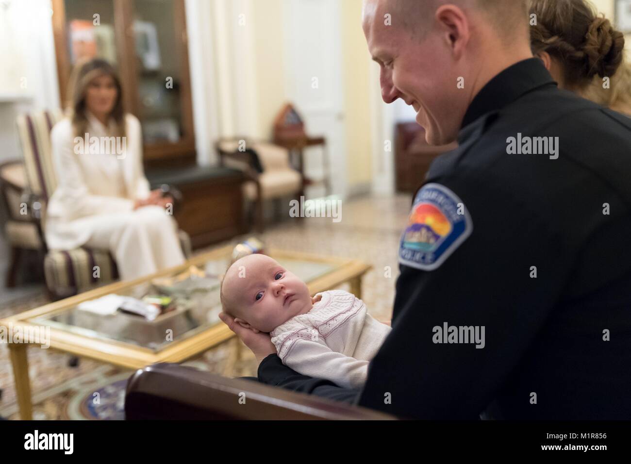 Albuquerque Police Officer Ryan Holets holds his adopted baby girl ...