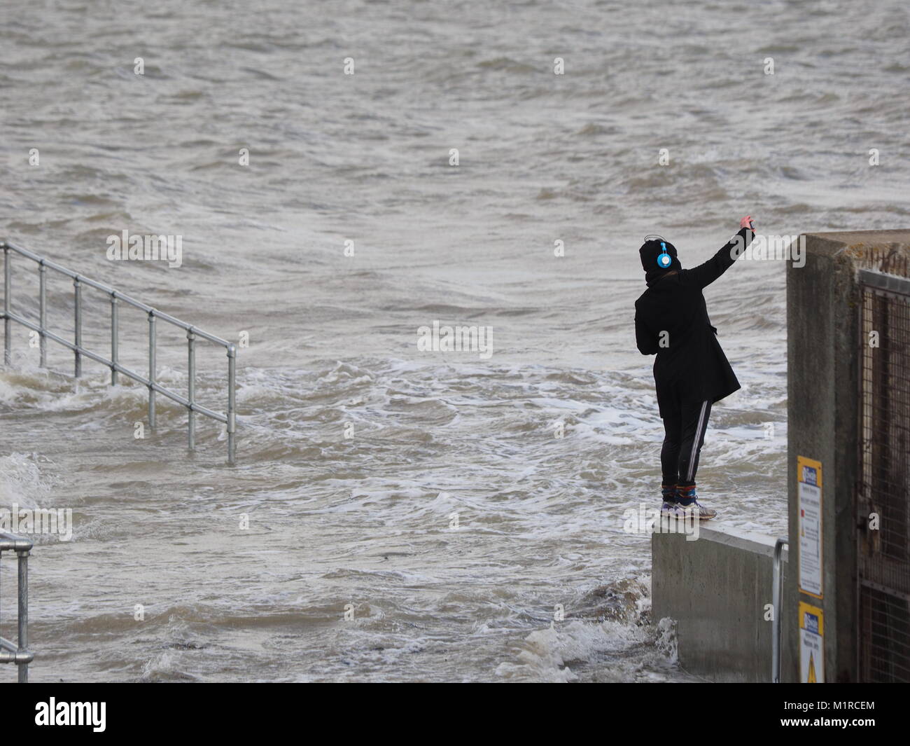 Sheerness, Kent, UK. 1st Feb, 2018. UK Weather: a young woman takes a ...