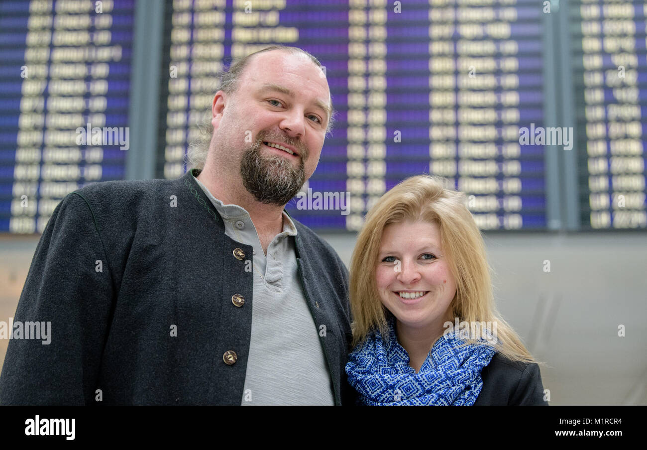 Social workers Jessica Guertler and Markus Jaehnert pose at the airport ...