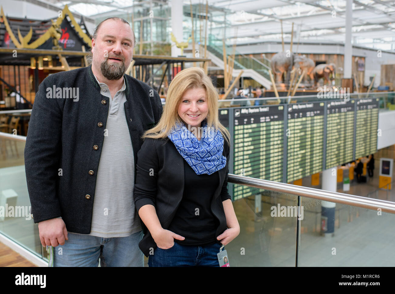 Social workers Jessica Guertler and Markus Jaehnert pose at the airport ...