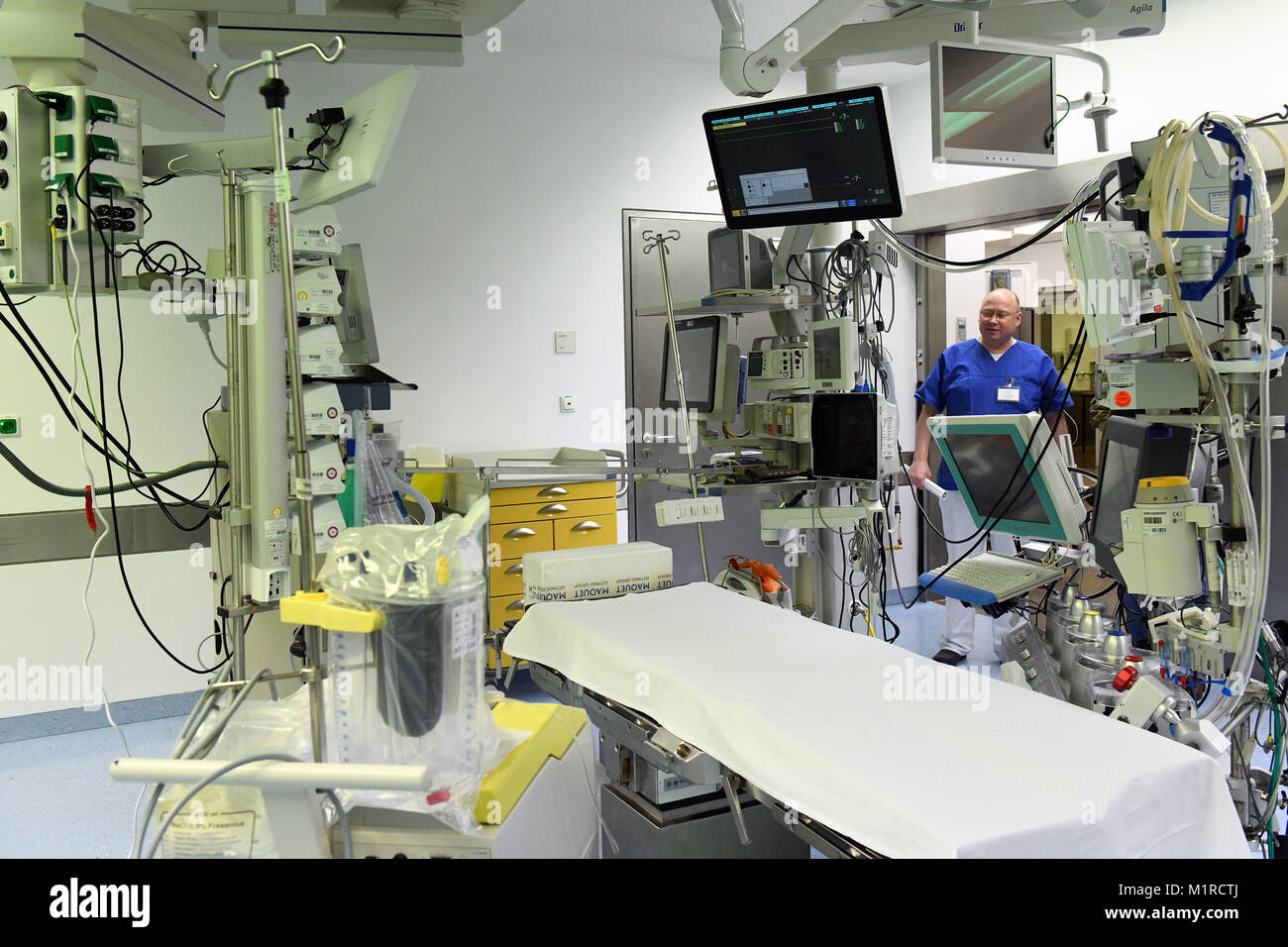 An employee stands inside a modernized heart surgery room if the ...