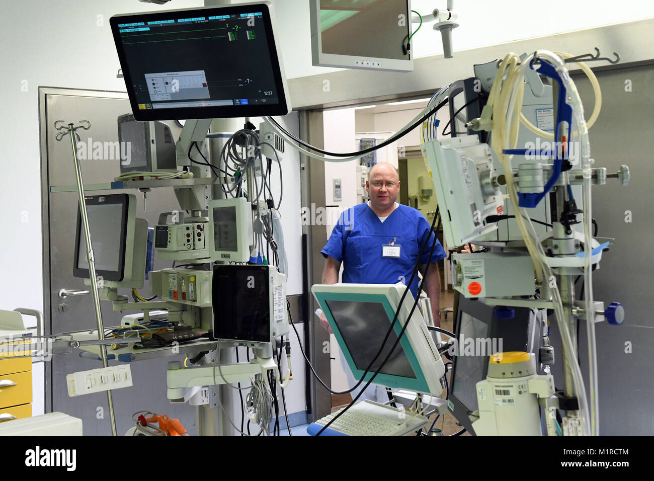 An employee stands inside a modernized heart surgery room if the ...
