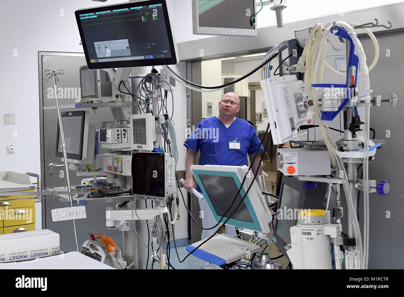 An employee stands inside a modernized heart surgery room if the ...
