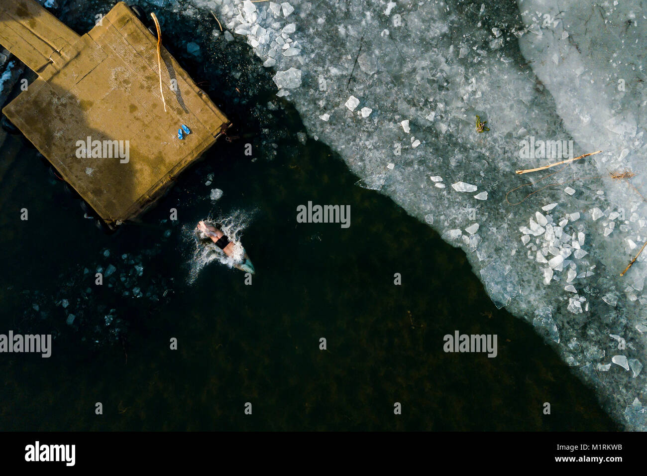 Anxin, China's Hebei Province. 1st Feb, 2018. A man swims near the ...