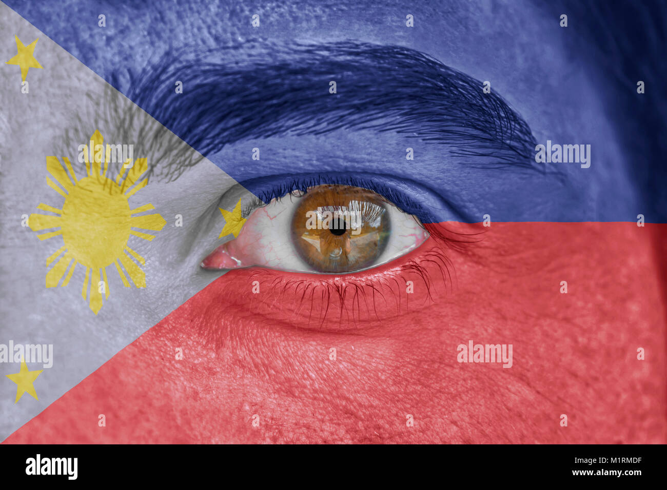 Human face and eye painted with flag of Philippines Stock Photo - Alamy