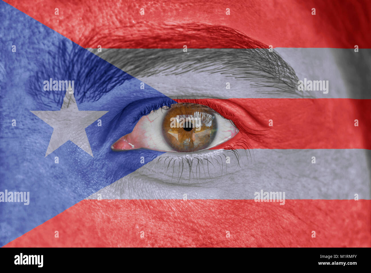 Human face and eye painted with flag of Puerto Rico Stock Photo - Alamy