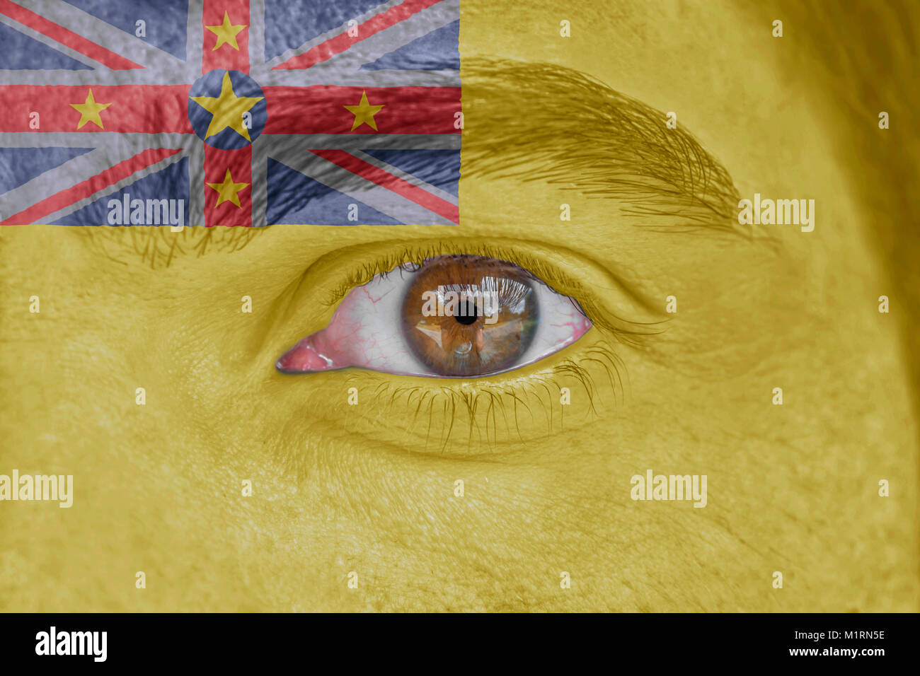 Human face and eye painted with flag of Rock of Polynesia iceland Niue ...