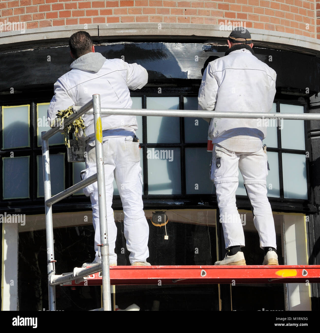 Amsterdam, Holland-February 5, 2015;Two painters working outside at a ...