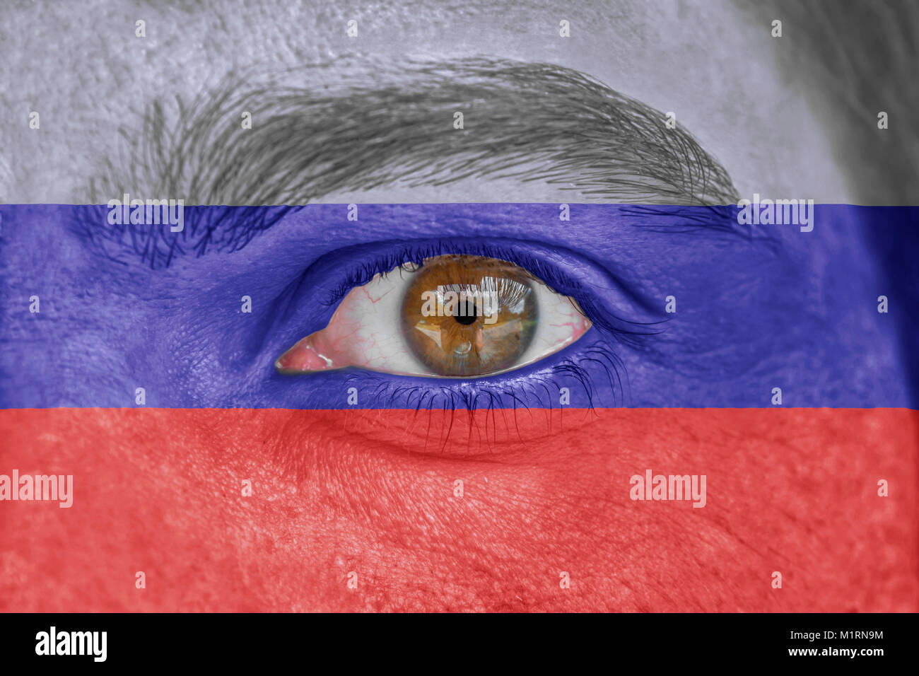 Human face and eye painted with flag of Russia Stock Photo - Alamy