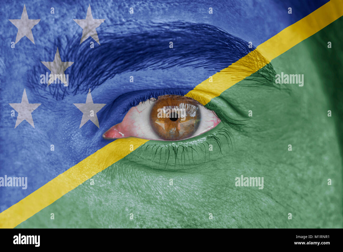 Human face and eye painted with flag of Solomon Islands Stock Photo - Alamy